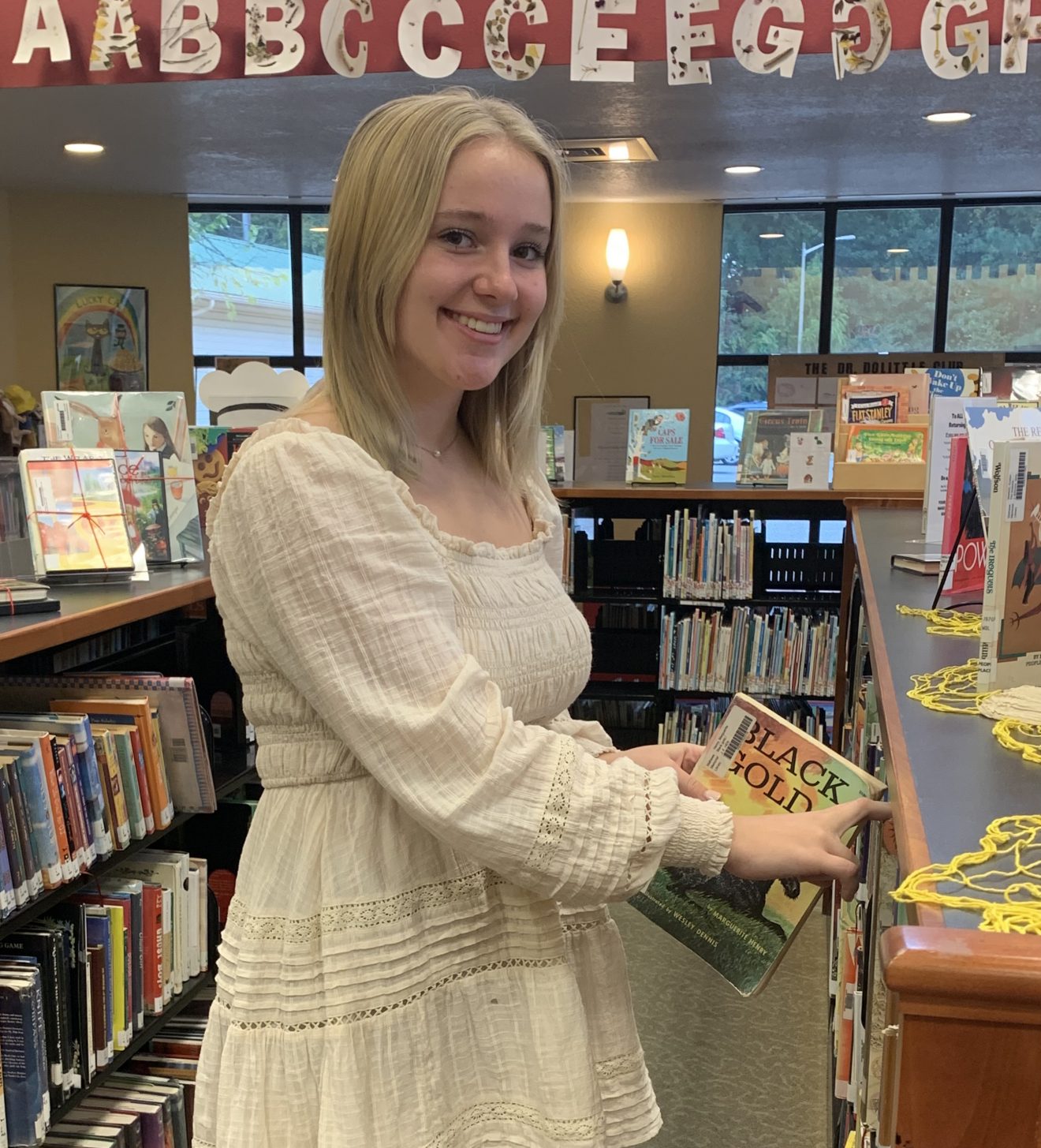 MHS student volunteering in youth wing of library - Gazette Journal